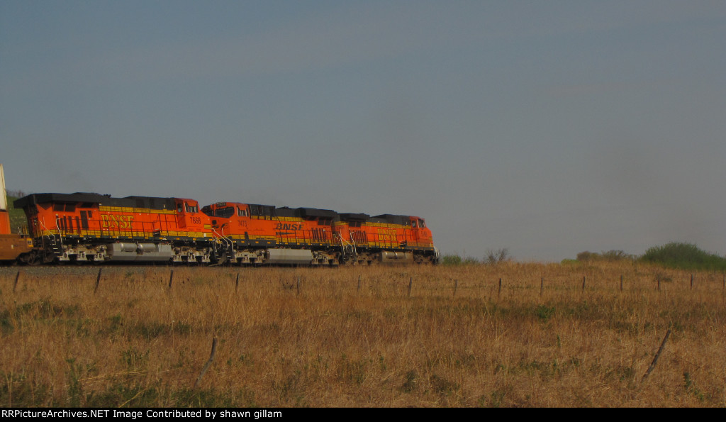 BNSF 7473 is 2nd out on this stack leaning hard into a cuvre.